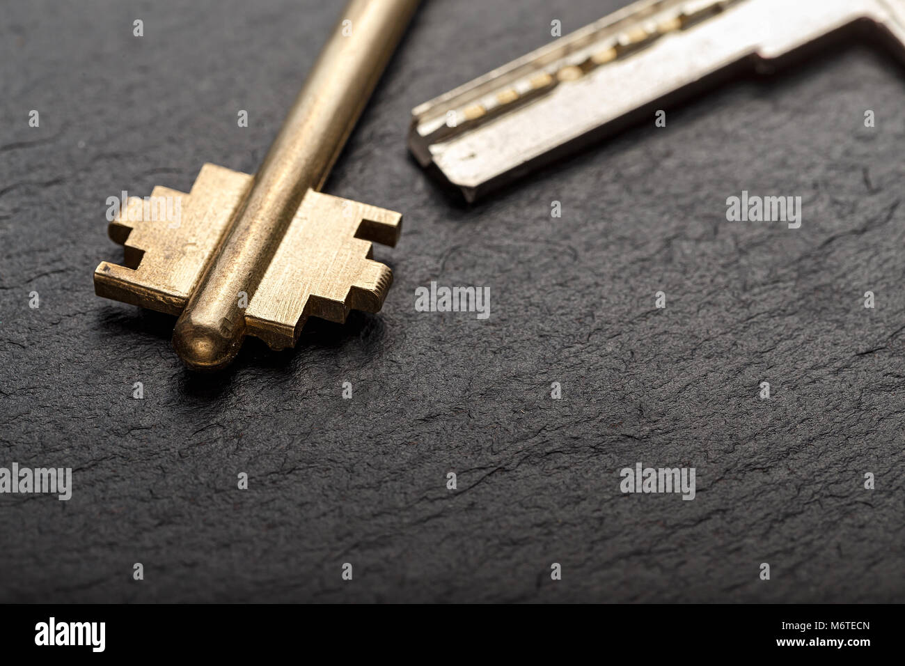 Bunch of golden metal keys on a black background, horizontal photo ...