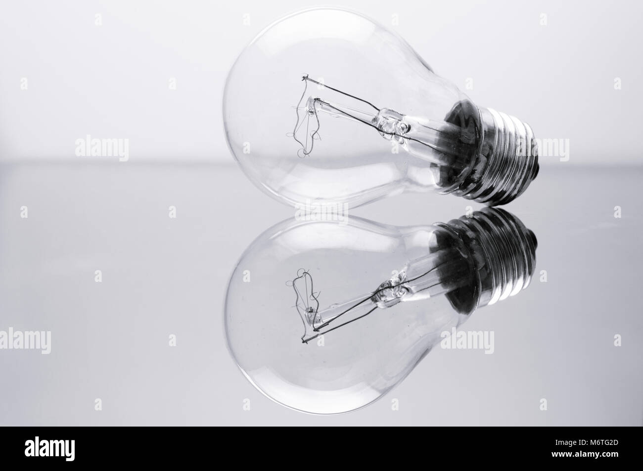 Light bulb and its reflection Stock Photo - Alamy