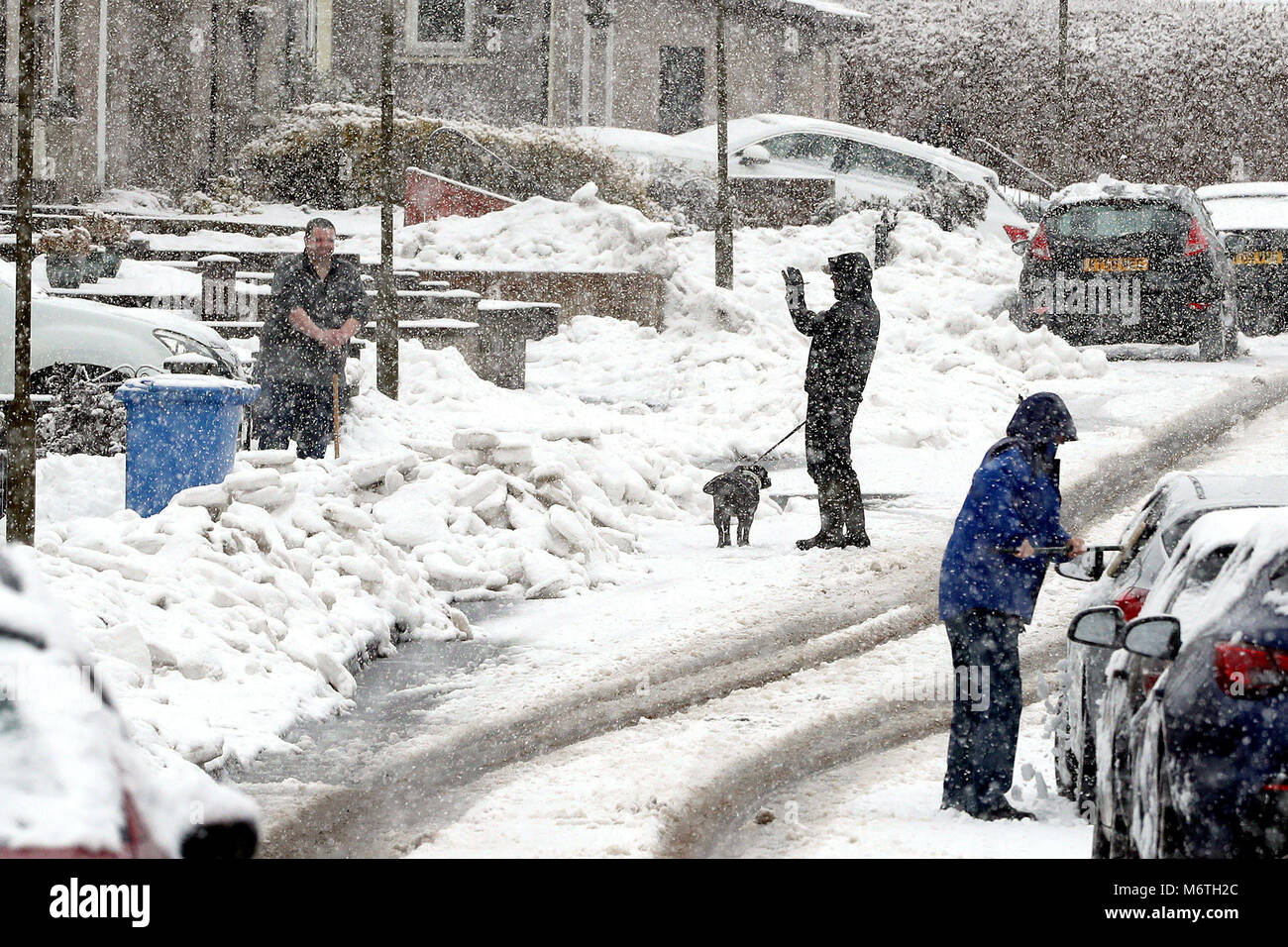 Residents in a street of Dunipace, Scotland during snowy conditions ...