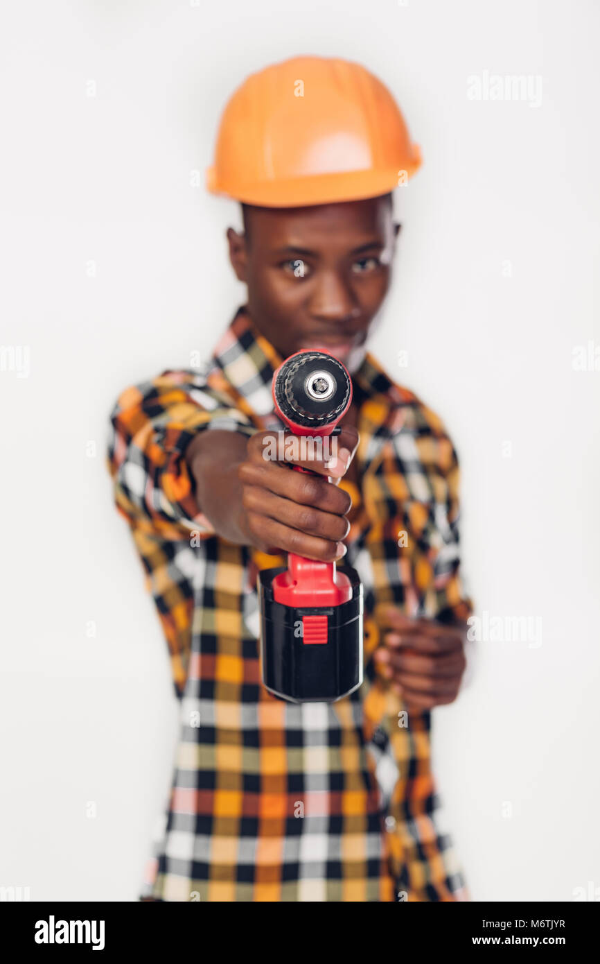 African American worker uses electric screwdriver Stock Photo - Alamy