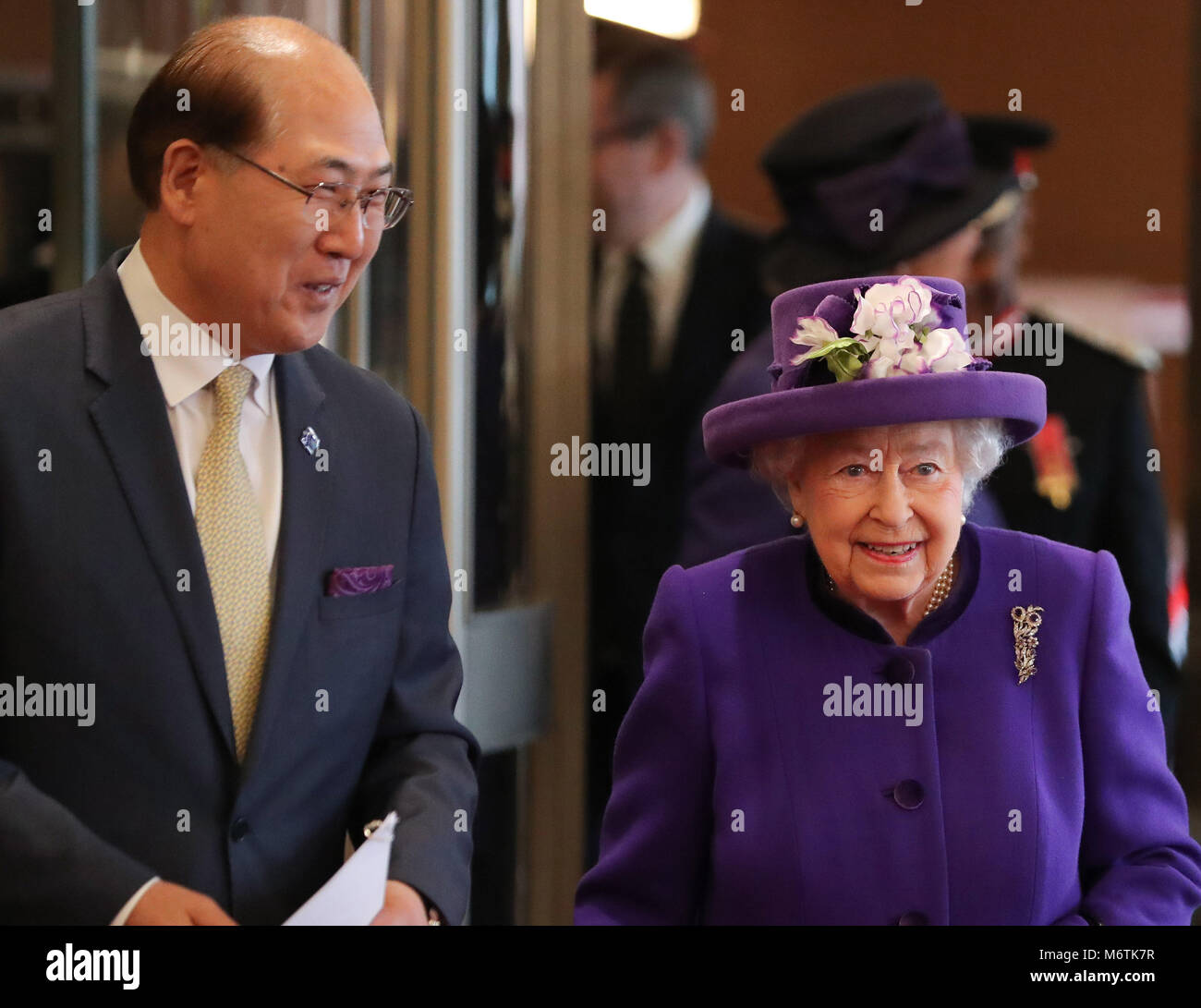Queen Elizabeth II walks with Secretary-General of the International ...