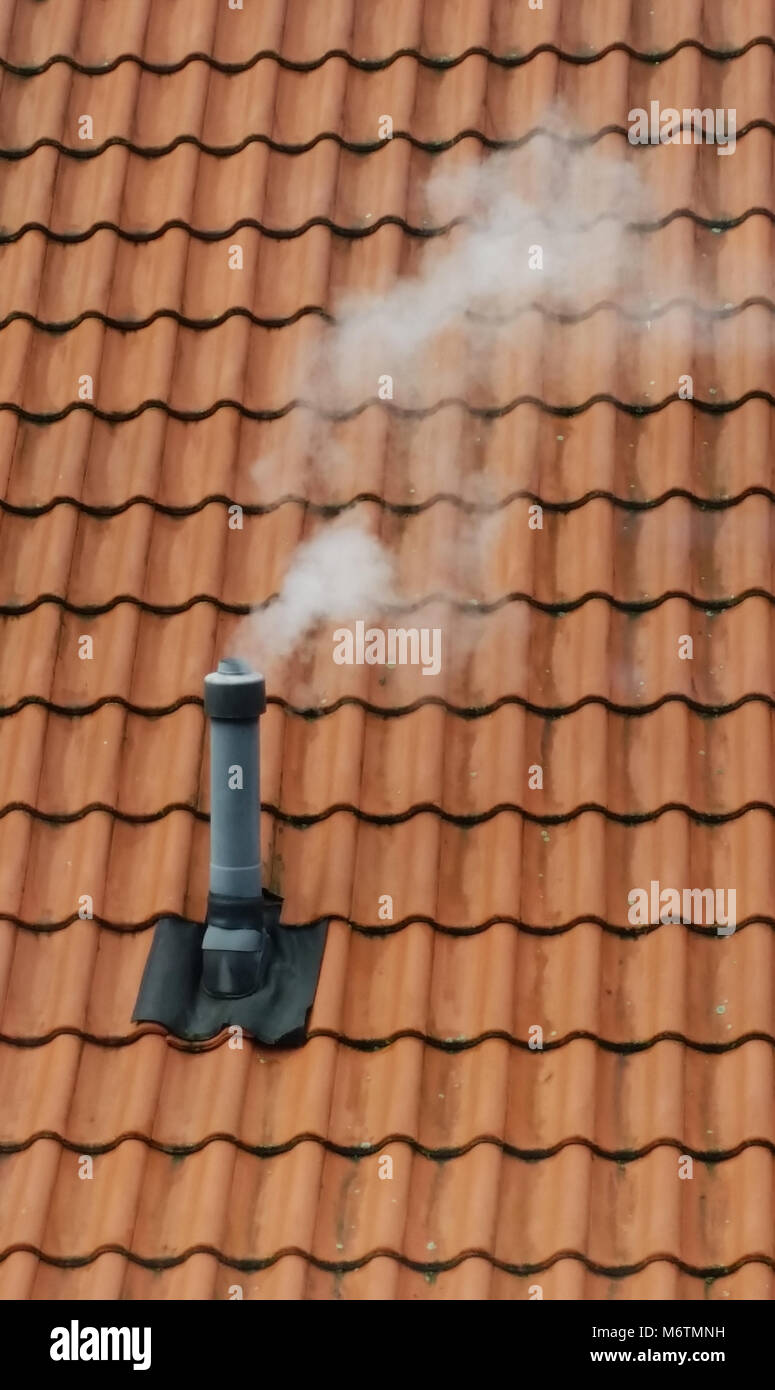 Smoking chimney on rooftop Stock Photo - Alamy