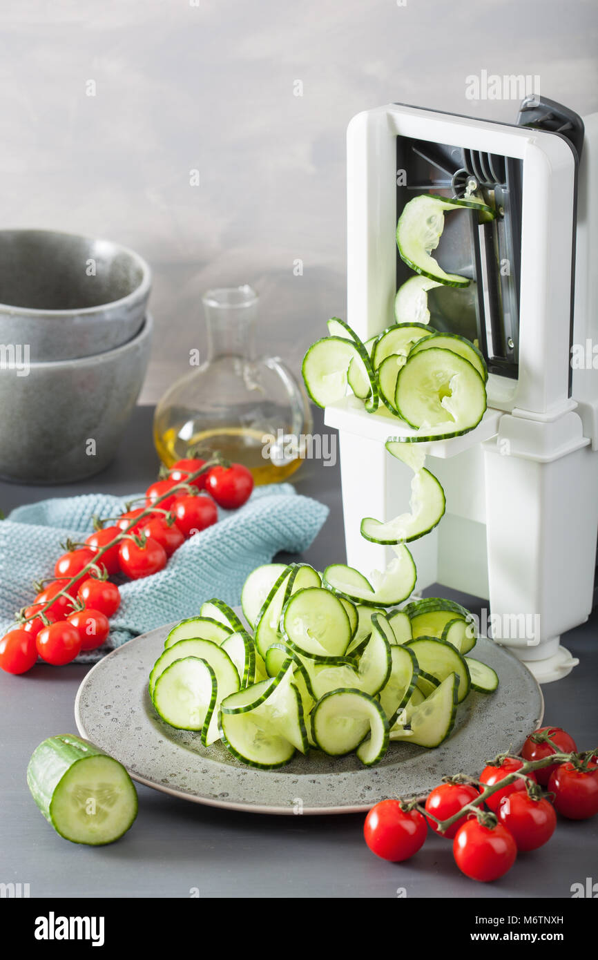 spiralizing cucumber vegetable with spiralizer Stock Photo - Alamy