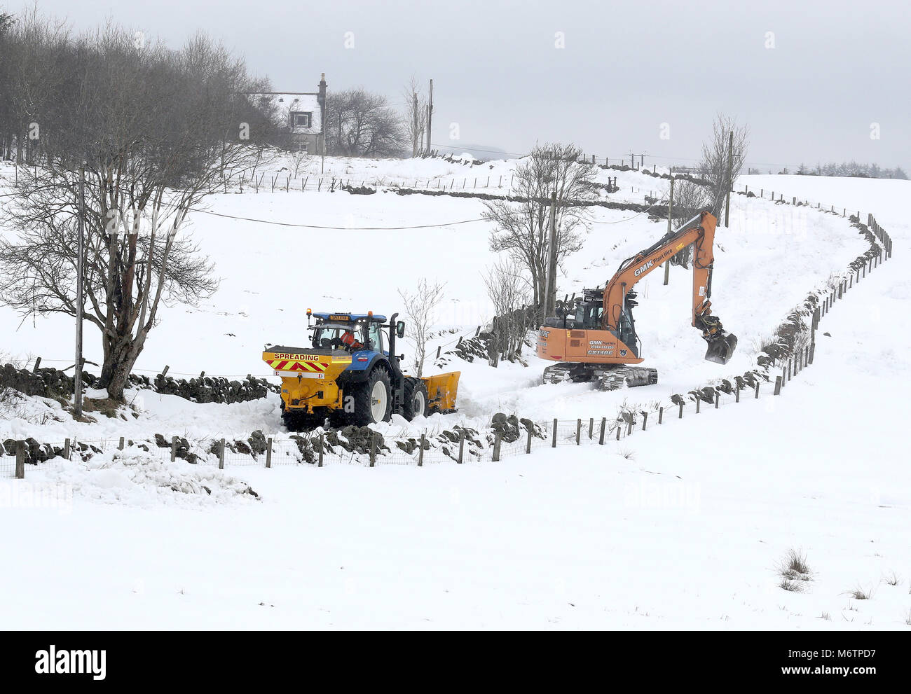 A digger and plough clear snow in rural Carron Valley during an attempt ...