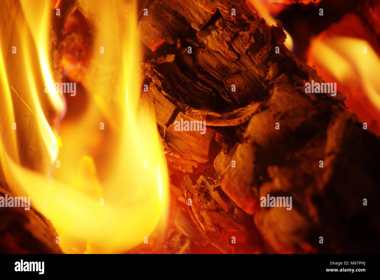 Detail view into fireplace ember wood. Glowing embers in hot red color ...