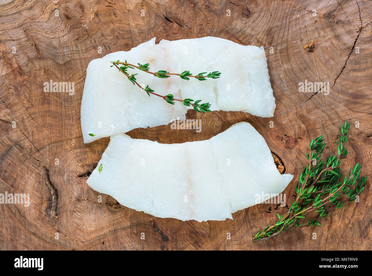 Raw haddock fillets on wooden board - top view Stock Photo - Alamy