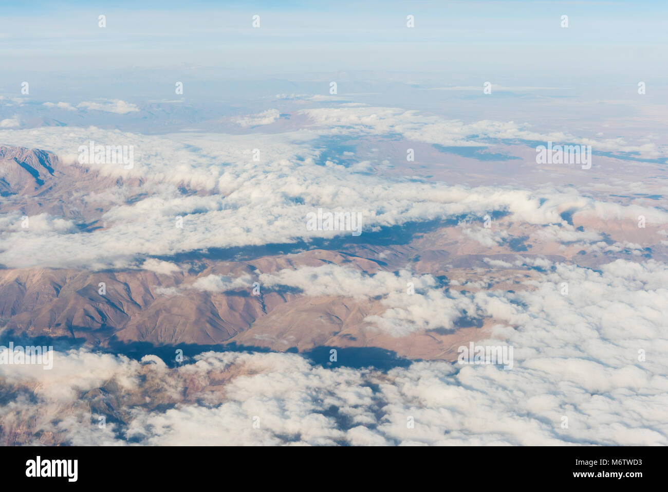 Airplane window view over the Argentinian high Andes mountains ...