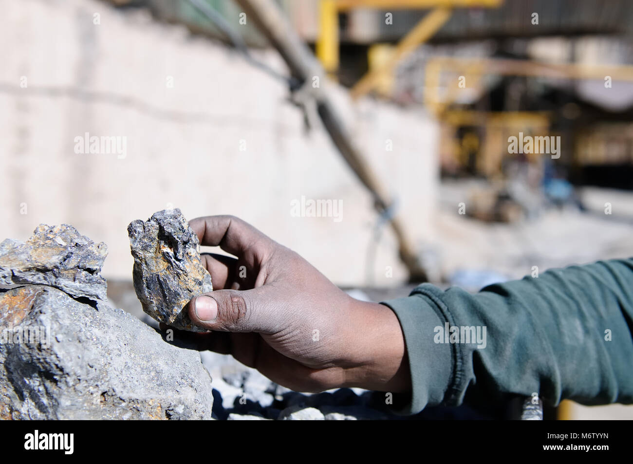 The Cerro Rico hillside and ore silver on the hand in the background of ...