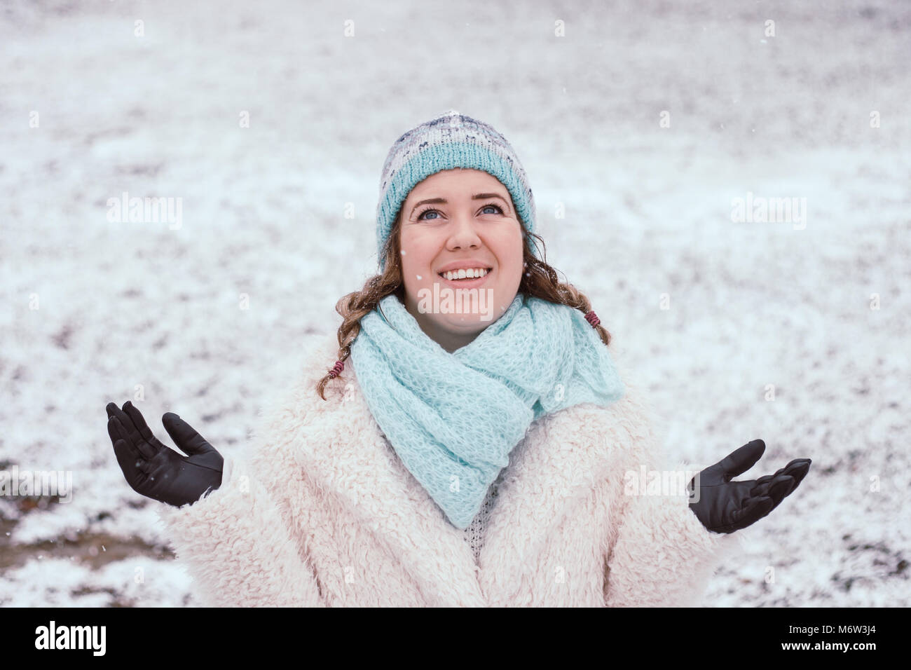 Smiling young woman in snowing outdoor Stock Photo - Alamy