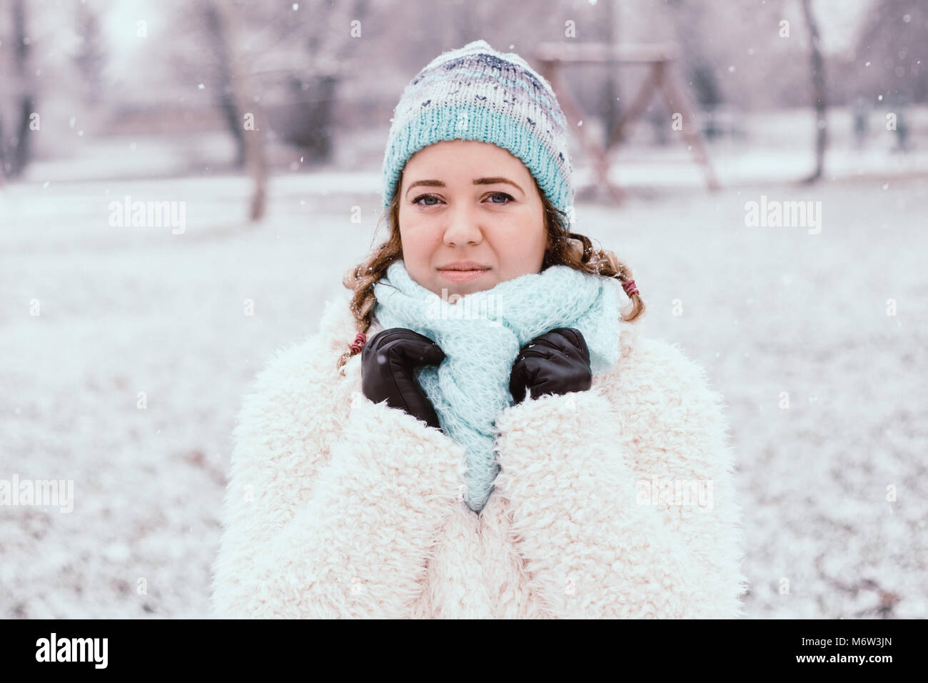 Smiling young woman in snowing outdoor Stock Photo - Alamy
