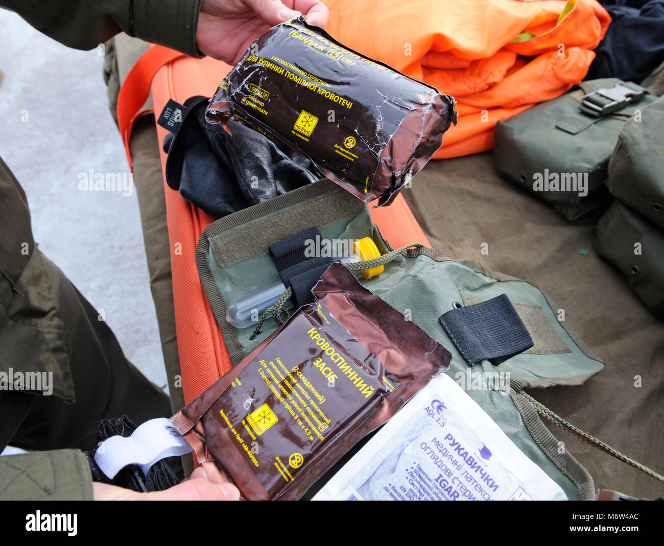 Instructing officer showing content of a first-aid kit for soldiers ...