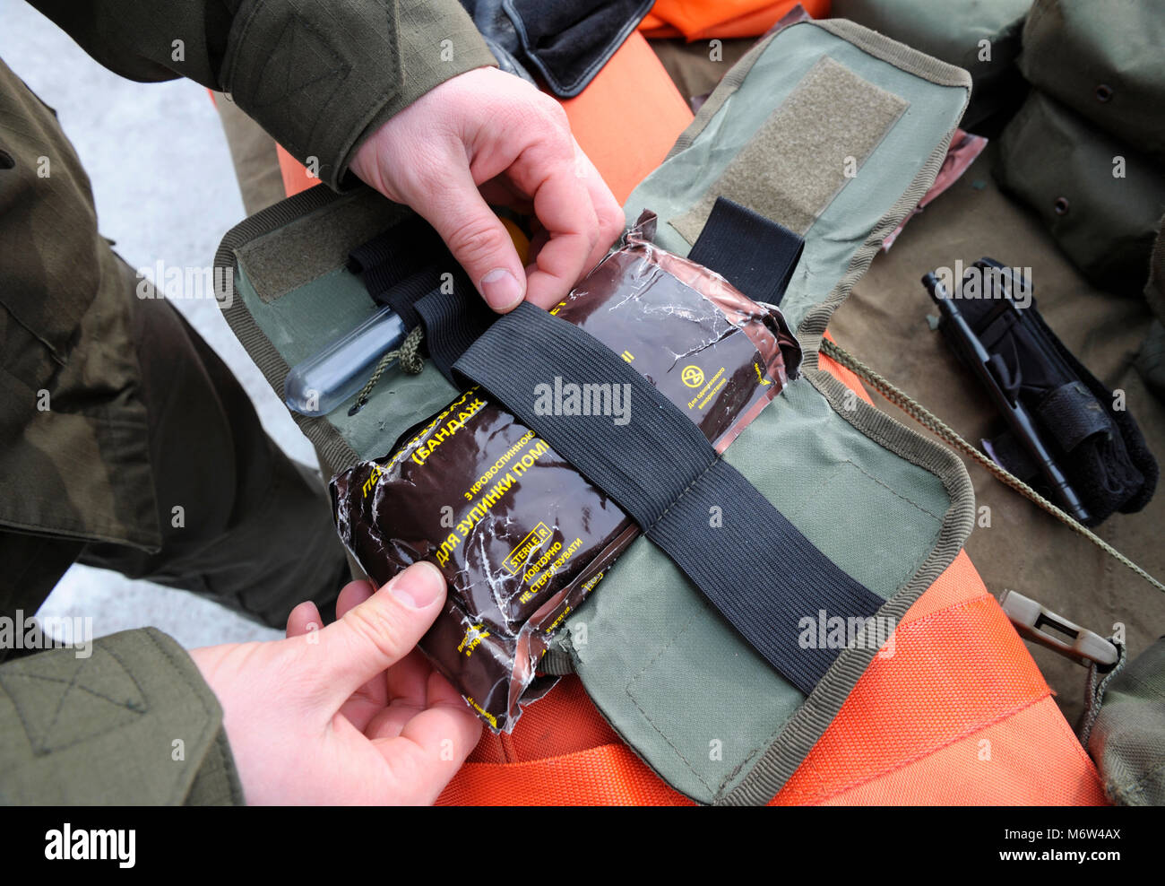 Instructing officer showing content of a first-aid kit for soldiers ...