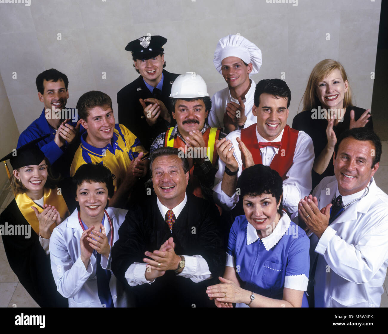 1996 HISTORICAL GROUP PORTRAIT OF SMILING CAUCASIAN WORKERS STANDING ...