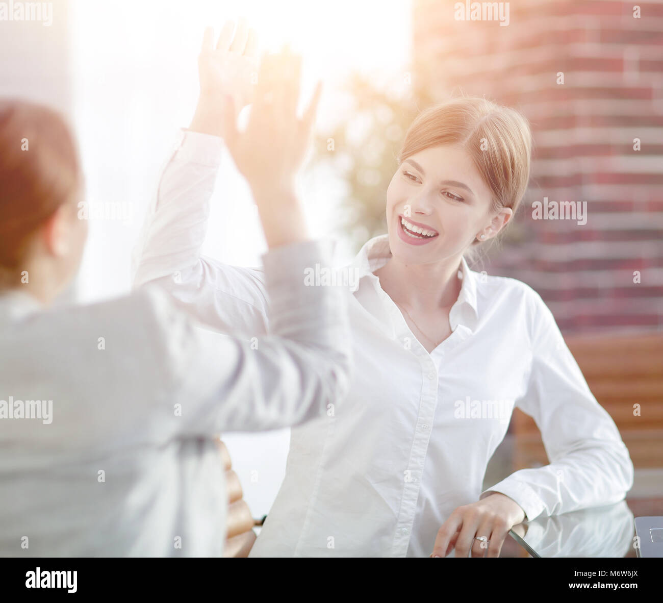 members of the business team giving each other a high five Stock Photo ...