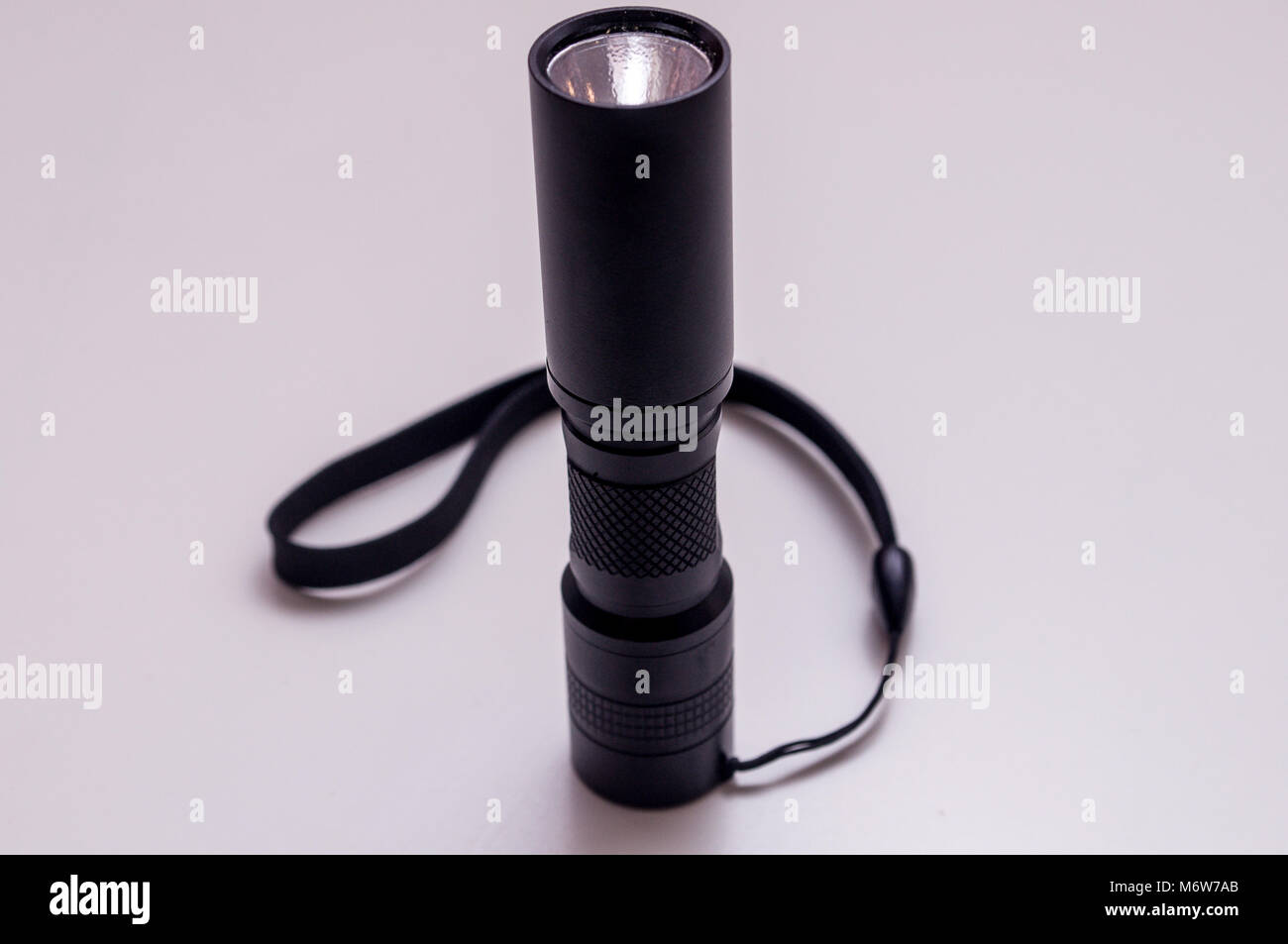 Torch with hand strap isolated on white background. LED aluminium ...