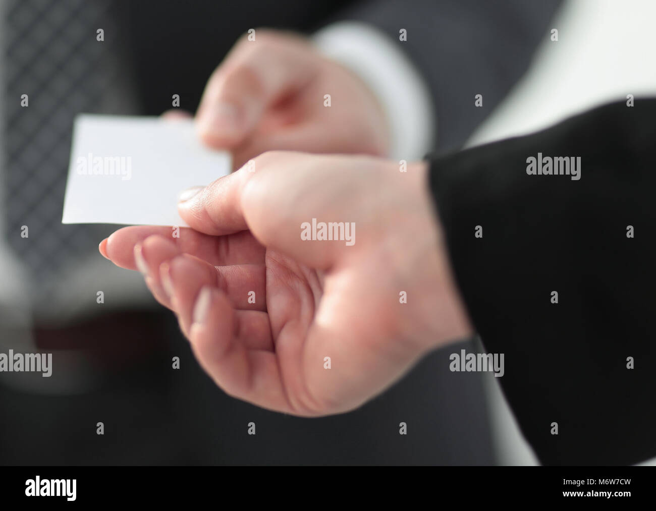 Exchange business card for first time meet Stock Photo - Alamy