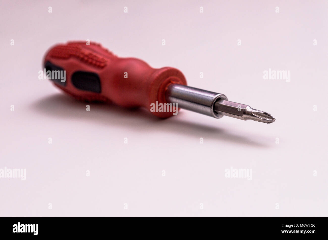 Cross Slot Screwdriver Screwdriver isolated on white. Black and red ...