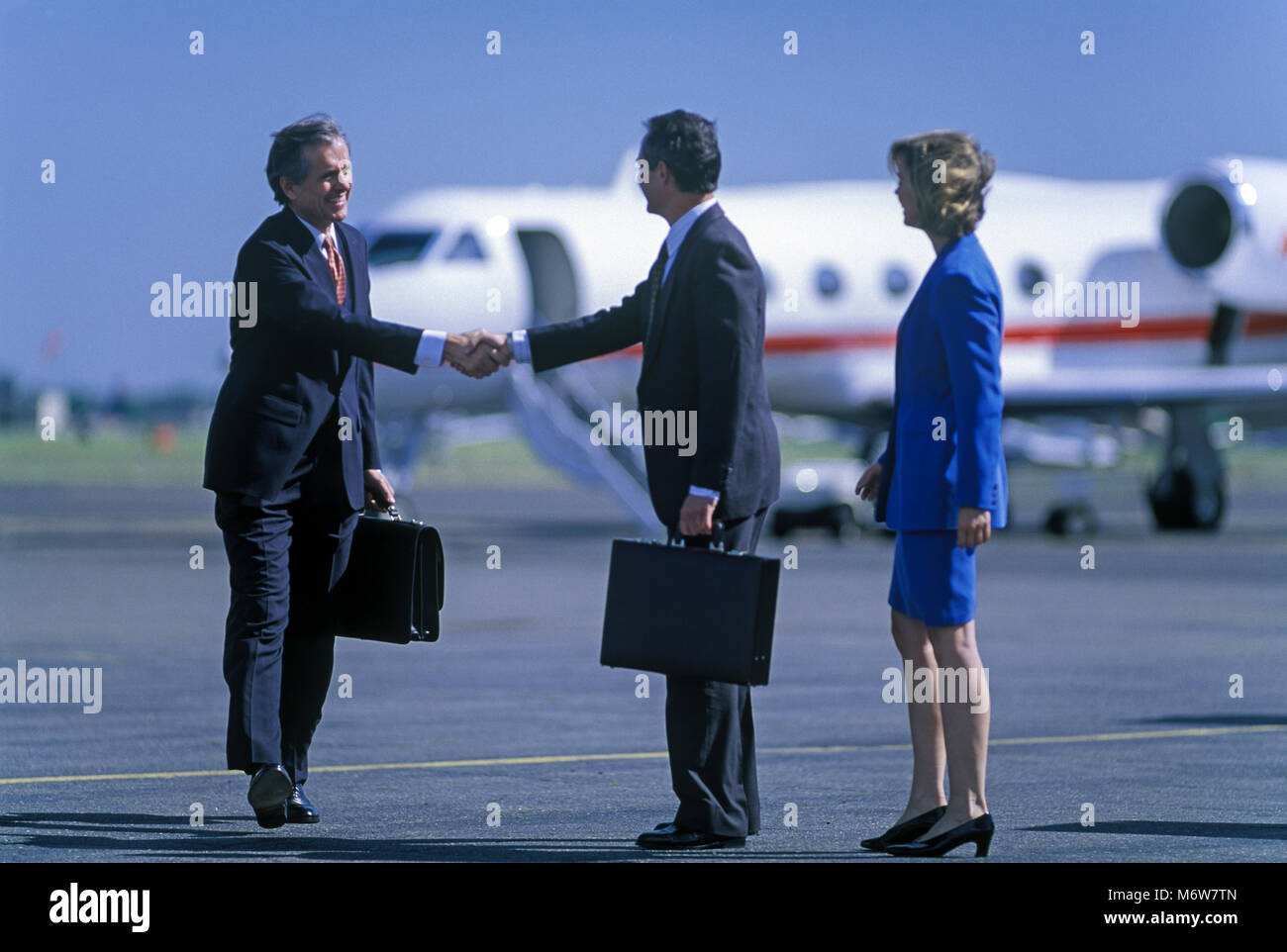1997 HISTORICAL CAUCASIAN BUSINESS PEOPLE HANDSHAKE BY PRIVATE JET ...