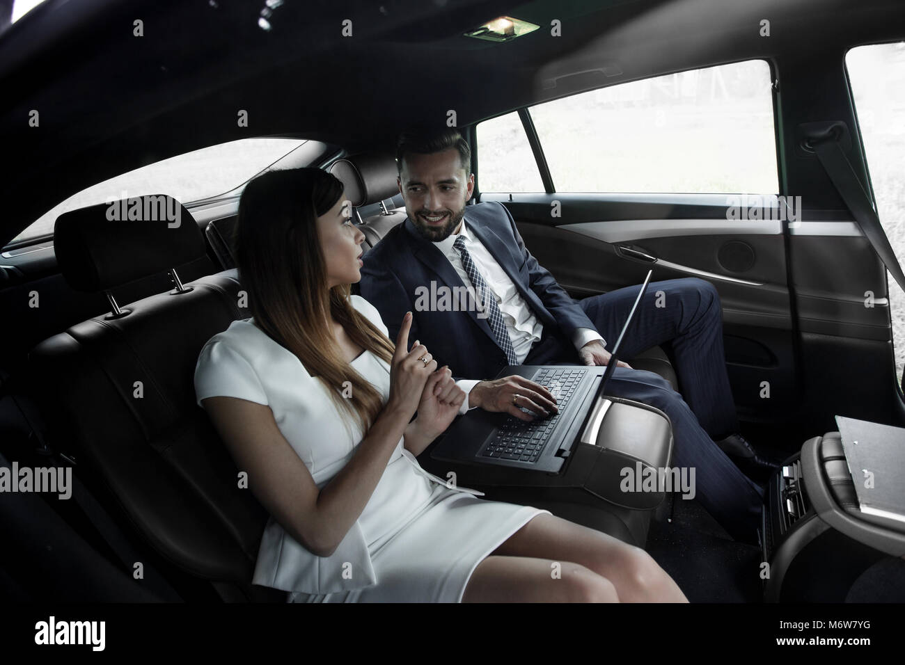 Conversation of two business people in driving car Stock Photo - Alamy