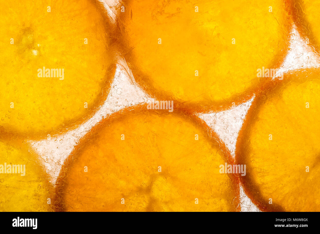 Slices of orange frozen in ice Stock Photo - Alamy