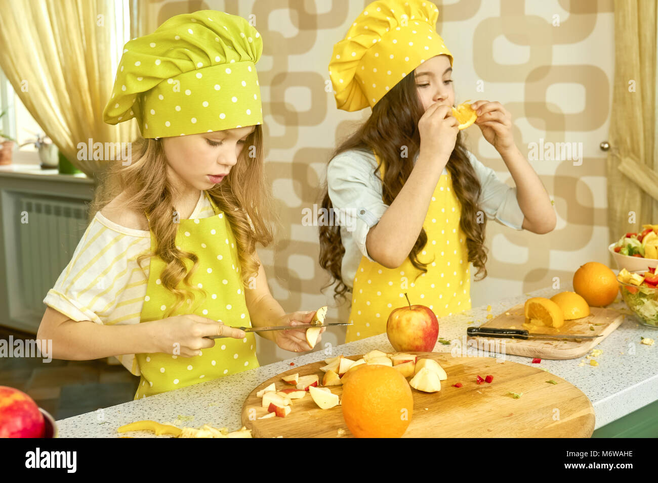 Two little girls cooking Stock Photo - Alamy