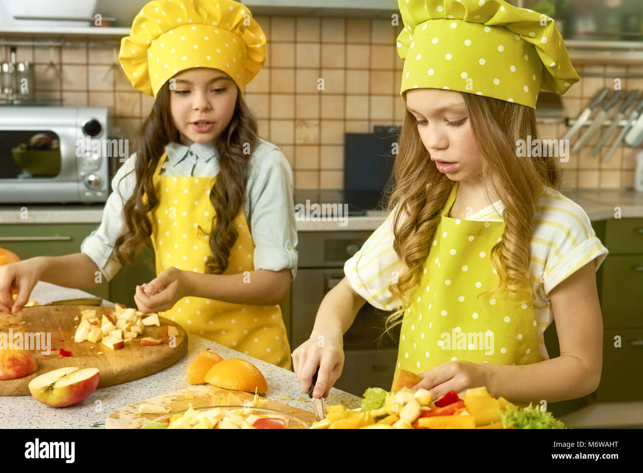 Little girls in the kitchen Stock Photo - Alamy
