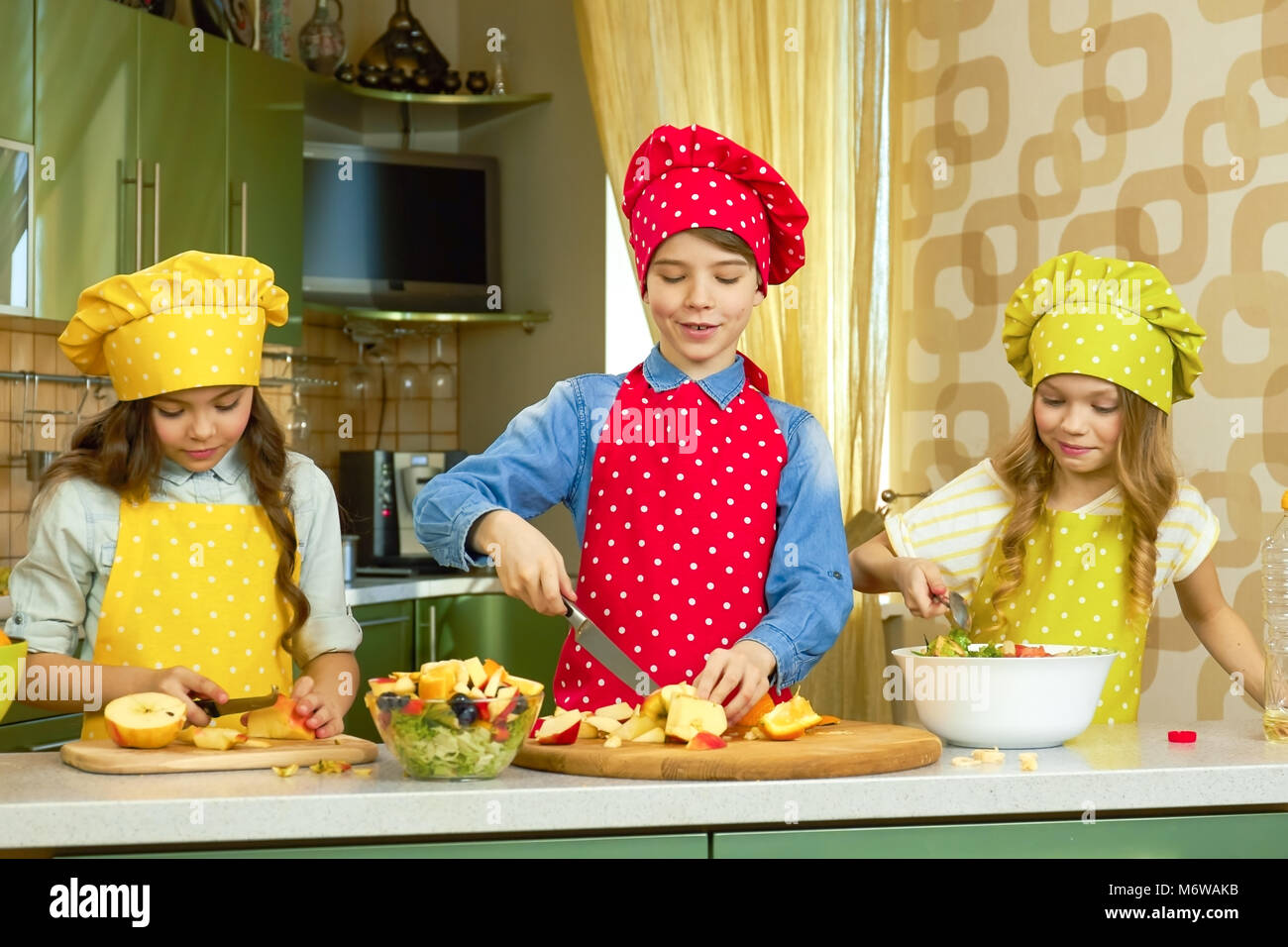 Kids making a salad Stock Photo - Alamy