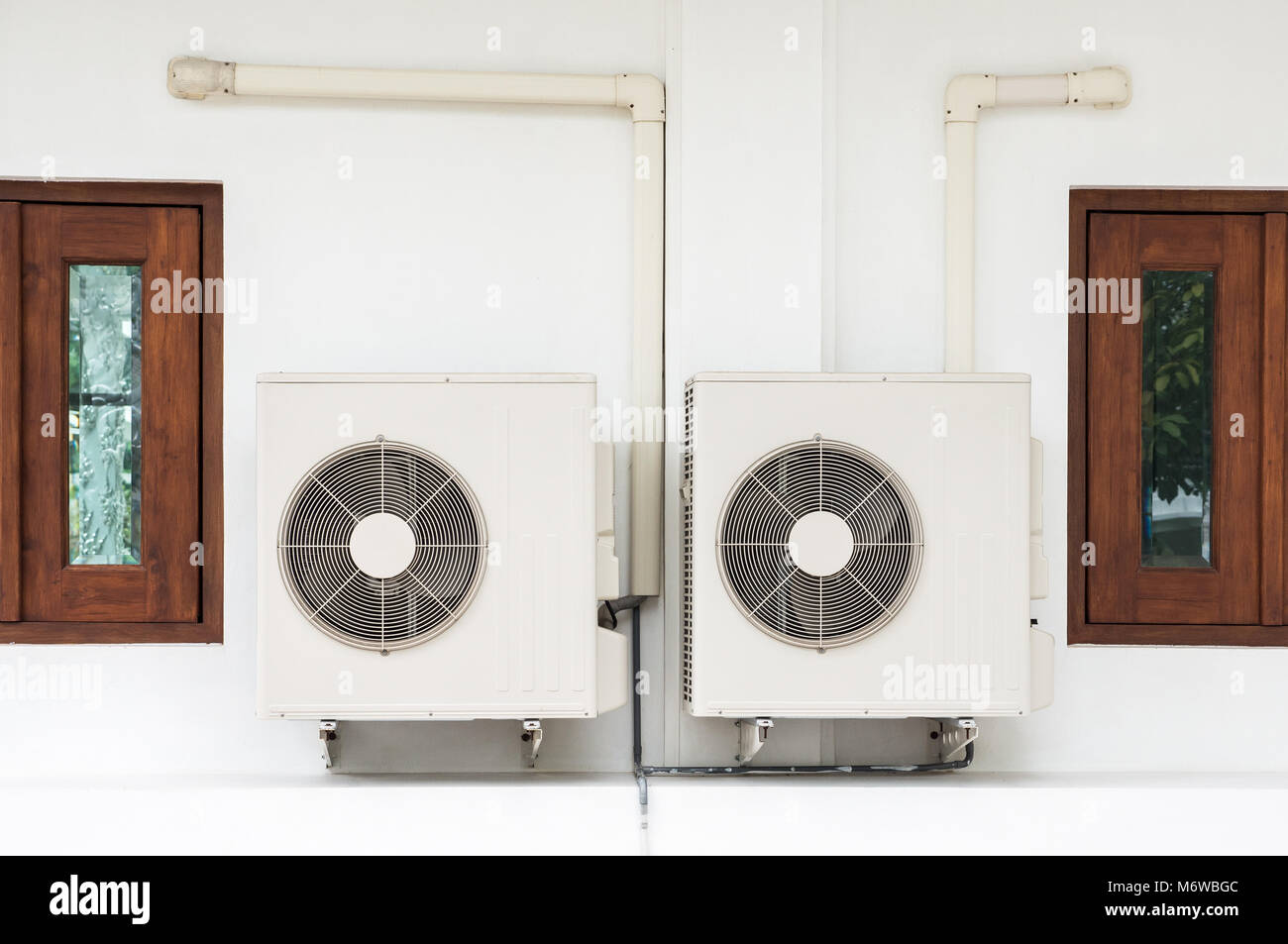 Compact air compressor unit is hanging near the window of the office ...