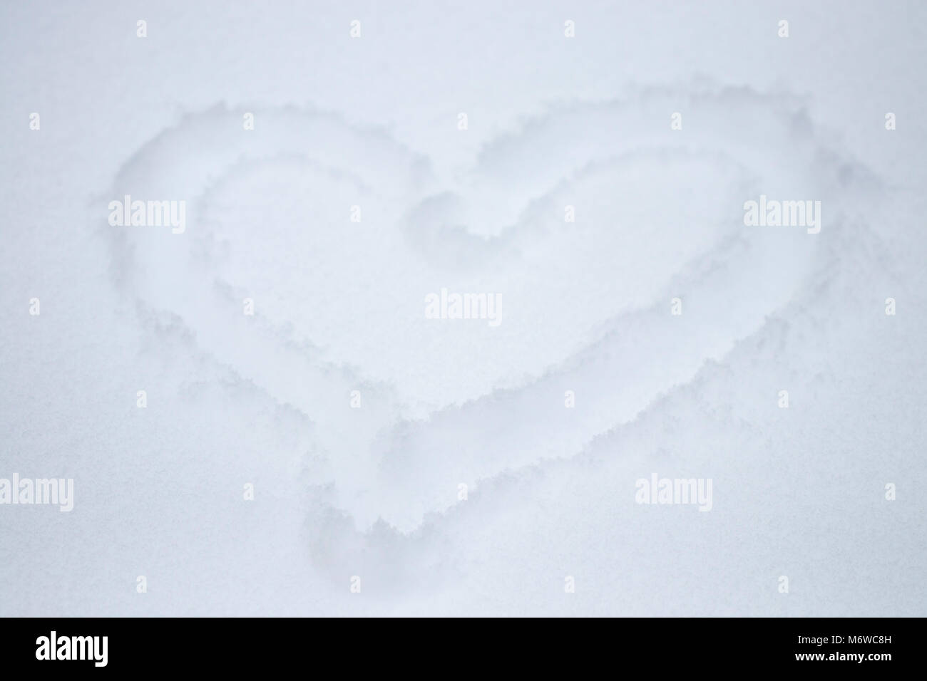hand drawn heart shape in the fresh snow Stock Photo - Alamy