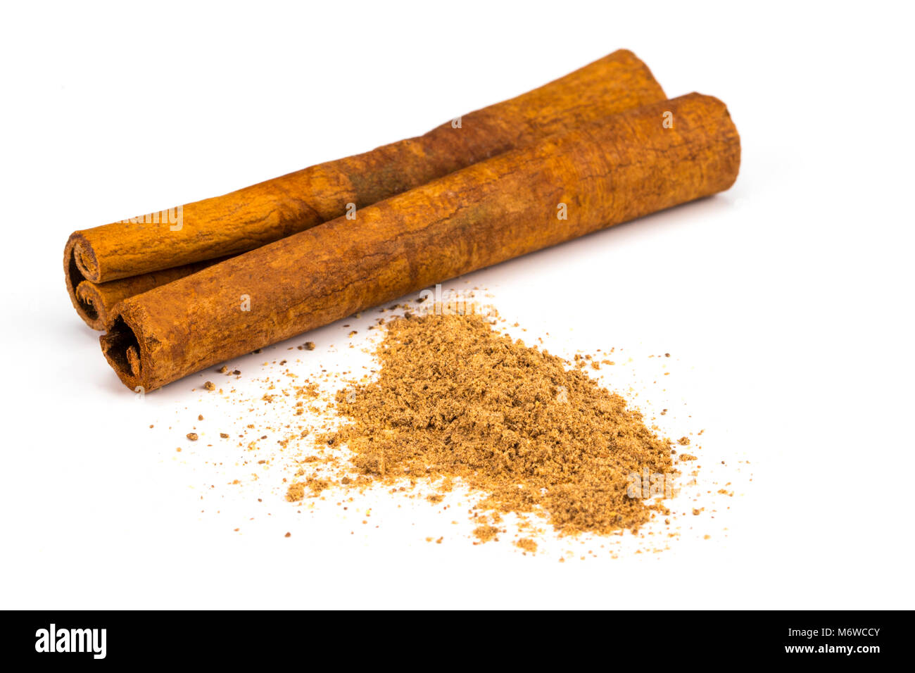 Cinnamon sticks and powder on white background Stock Photo - Alamy