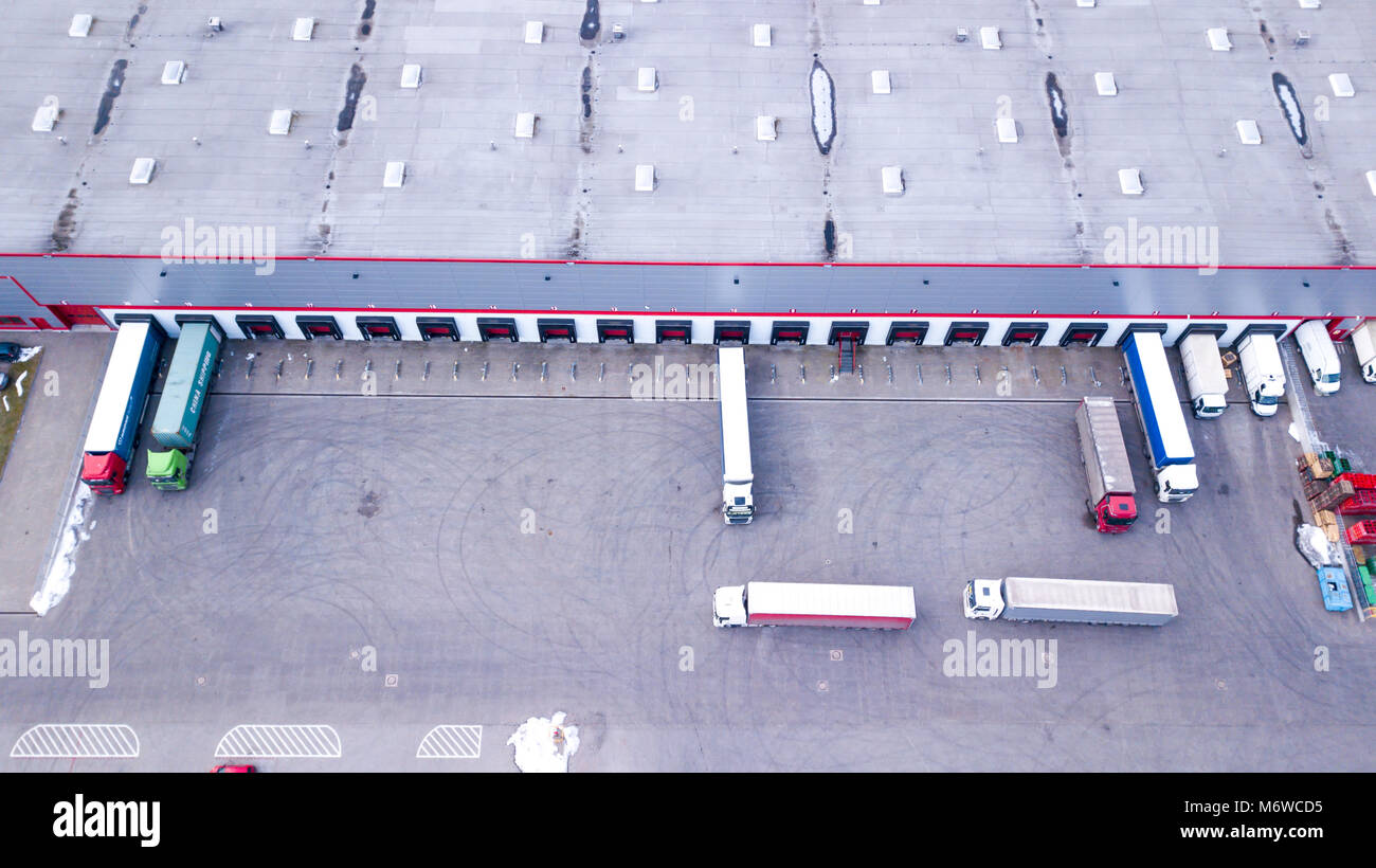 Aerial Shot of Industrial Warehouse Loading Dock where Many Truck with ...