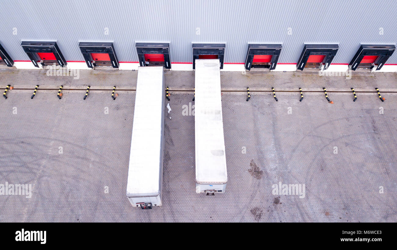 Aerial Shot of Industrial Warehouse Loading Dock where Many Truck with ...