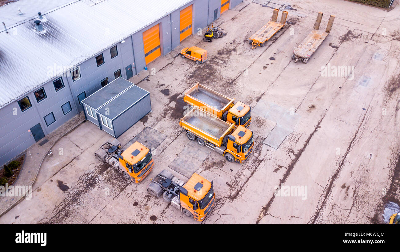 Aerial view over a workshop, factory, recycling facility, warehouse ...