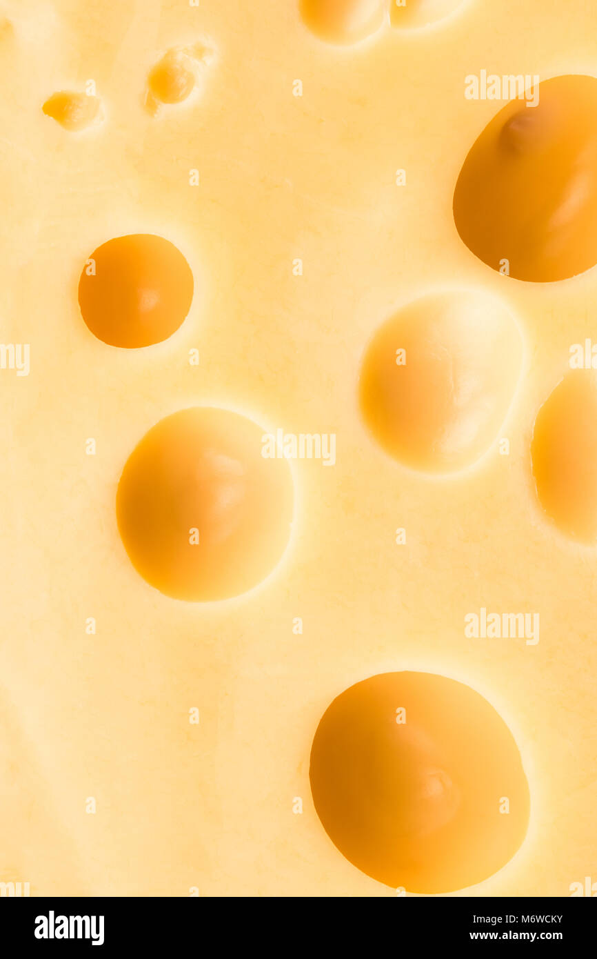 Texture of the cheese. Pattern of cheese with large holes Stock Photo ...