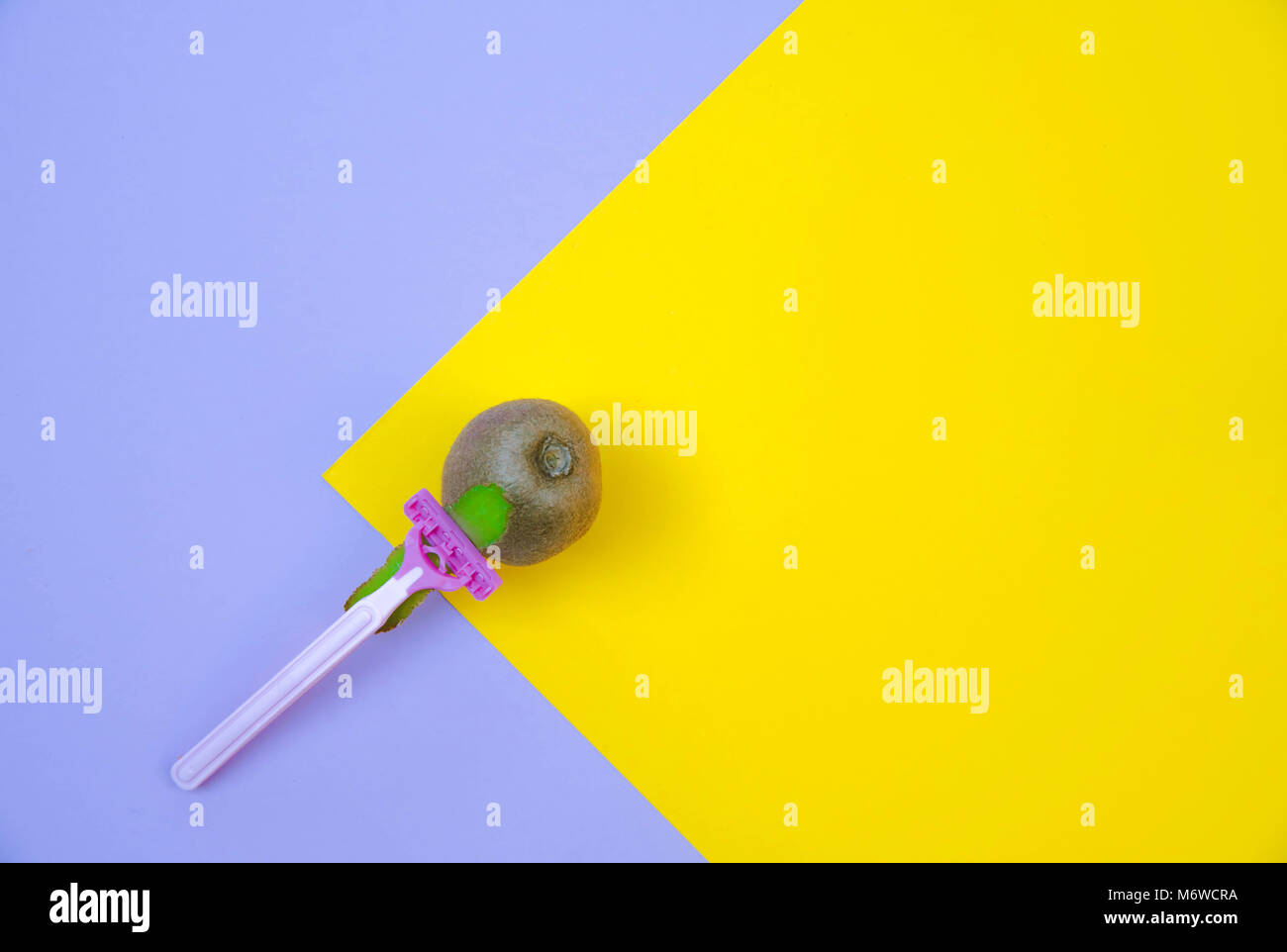 Kiwi fruit and razor on violet and yellow background. Hair removal ...