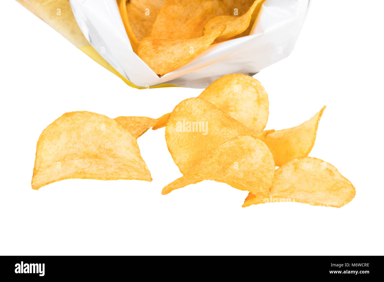 Potato chips poured out from packing on a white background Stock Photo ...