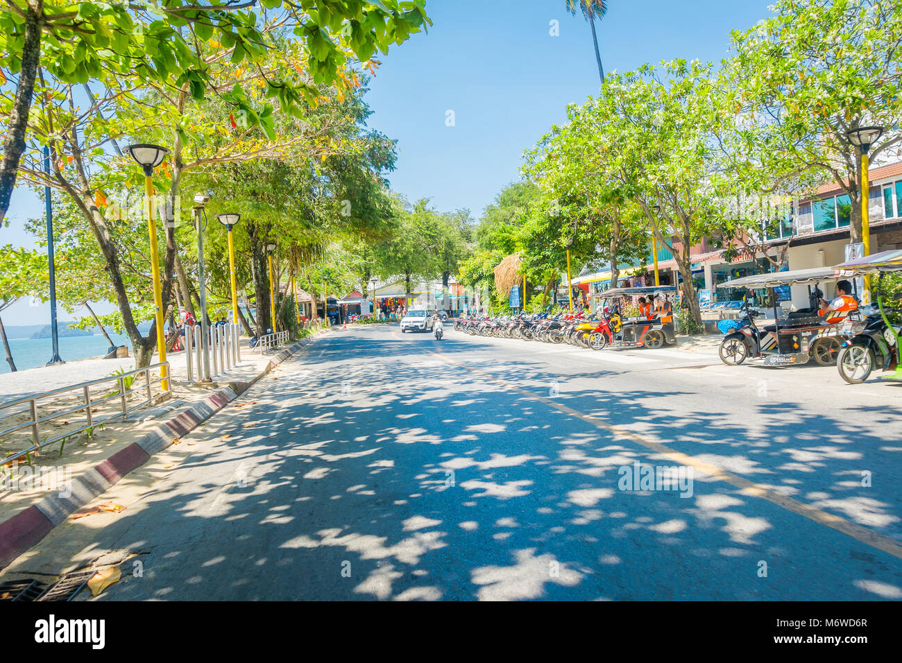 AO NANG, THAILAND - MARCH 19, 2018: Outdoor view of motorcycles parked in the street close to ...