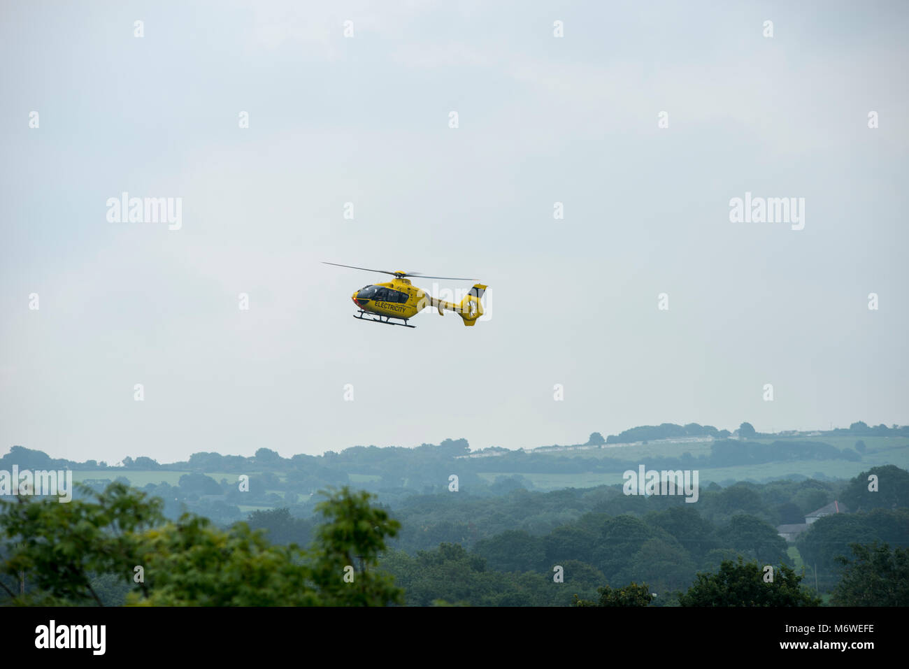 Yellow helicopter flying in wales hi-res stock photography and images ...