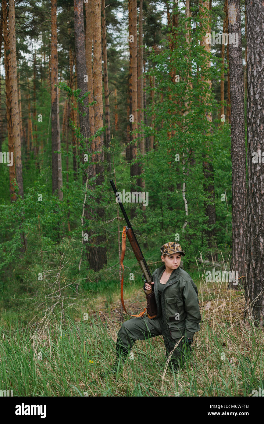 Woman hunter with a gun. Hunting in the woods Stock Photo - Alamy