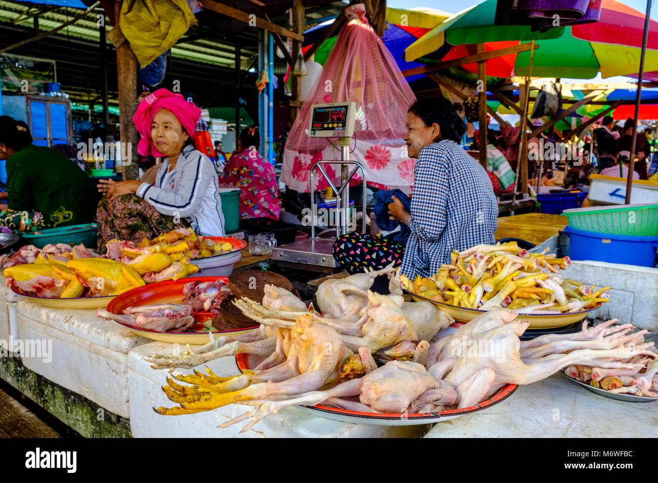 A local farmers woman is selling chicken meat in the street market of ...