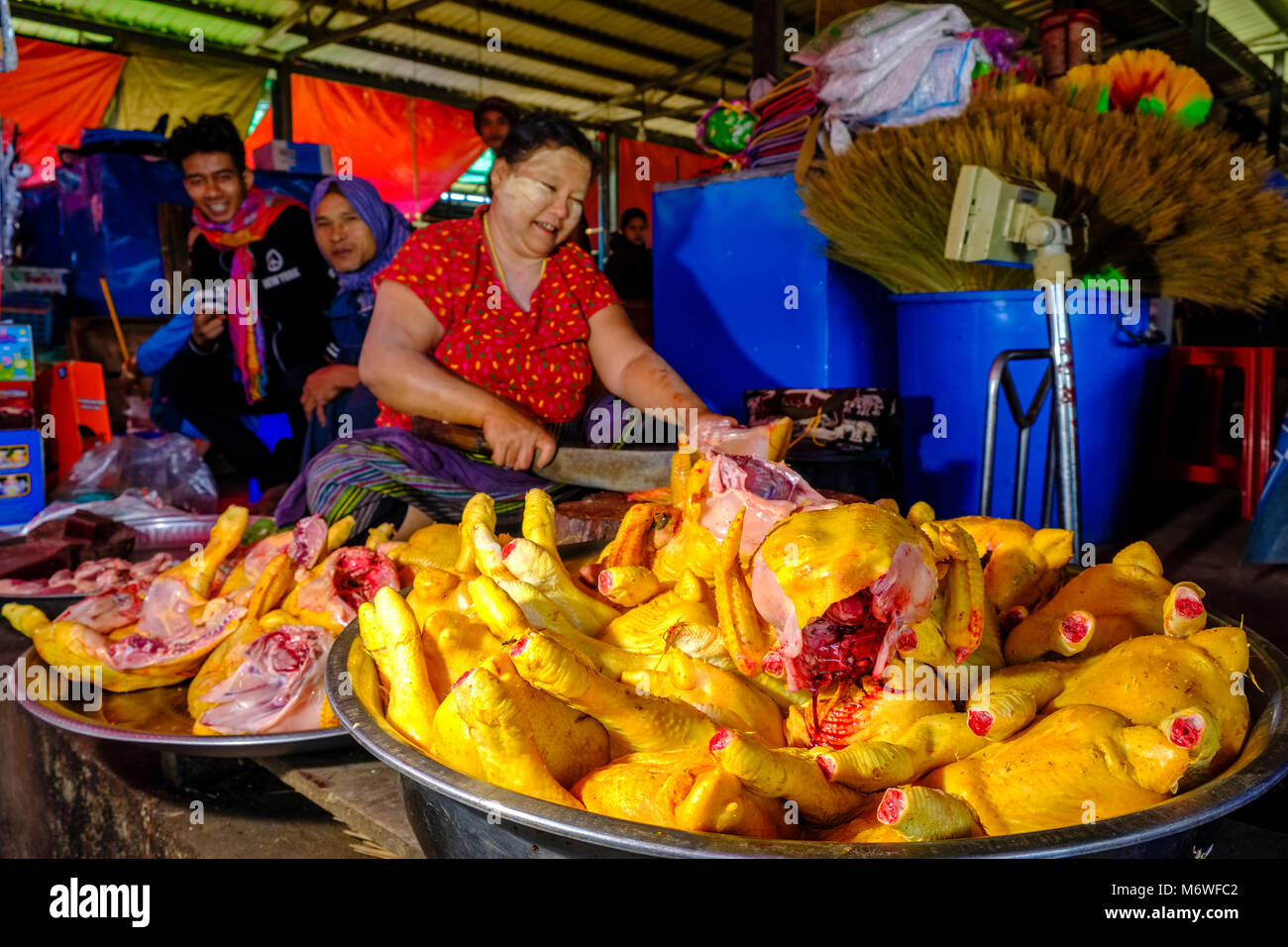 A local farmers woman is selling chicken meat in the street market of ...