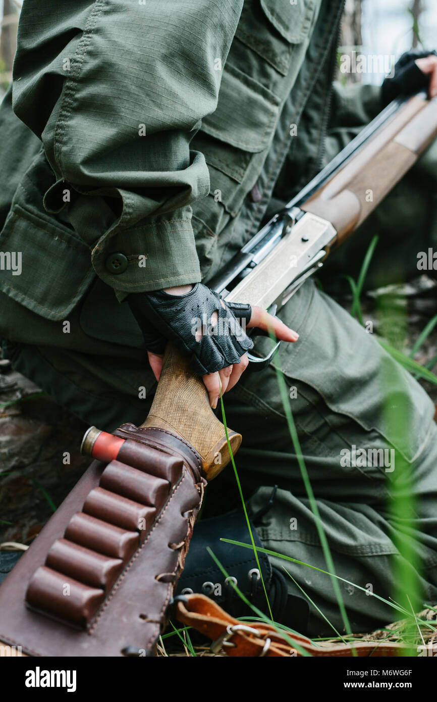 Woman hunter holding a gun in the woods. Hunting Stock Photo - Alamy