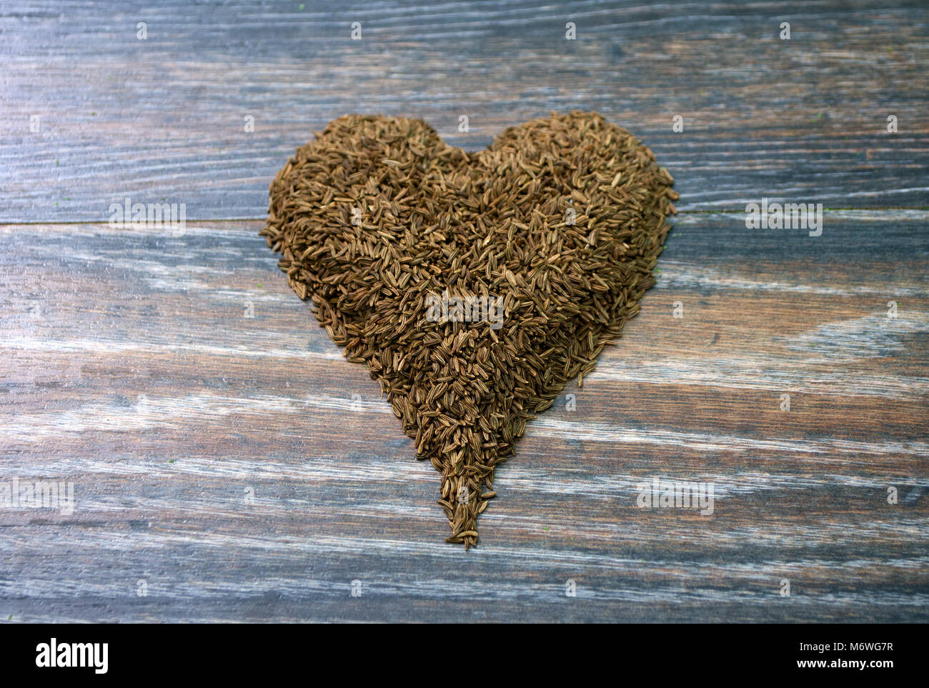 Various forms of carum carvi on a wooden background Stock Photo - Alamy