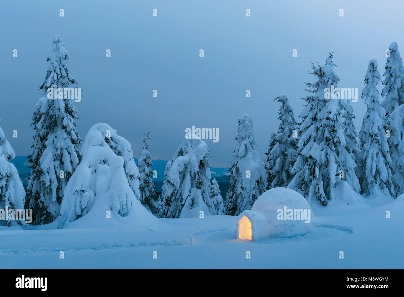 Snow igloo luminous from the inside Stock Photo - Alamy