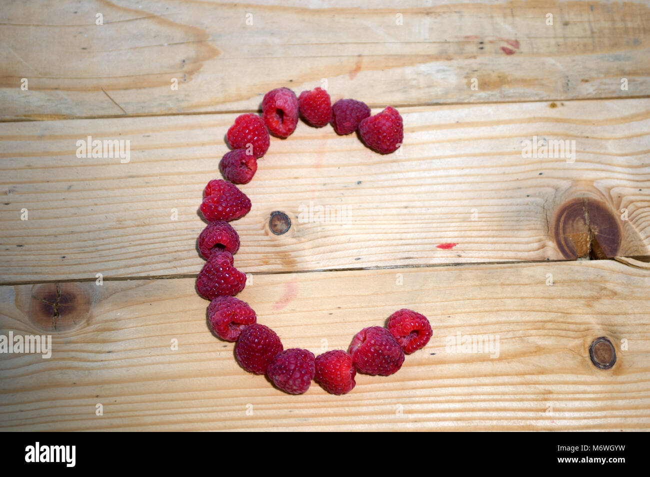 Alphabetical letters made of raspberries on a white background Stock ...