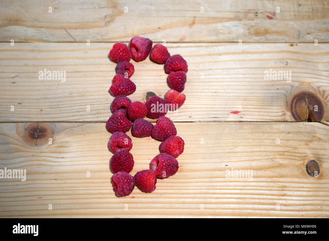 Alphabetical letters made of raspberries on a white background Stock ...