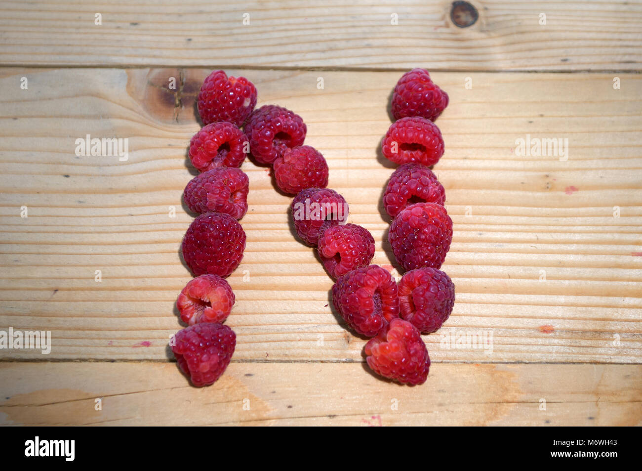 Alphabetical letters made of raspberries on a white background Stock ...