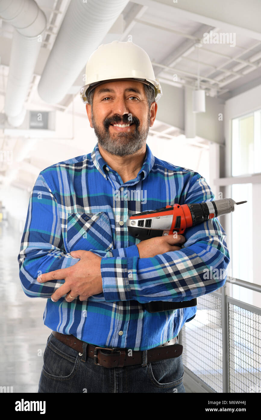 Senior Hispanic contractor inside building Stock Photo - Alamy