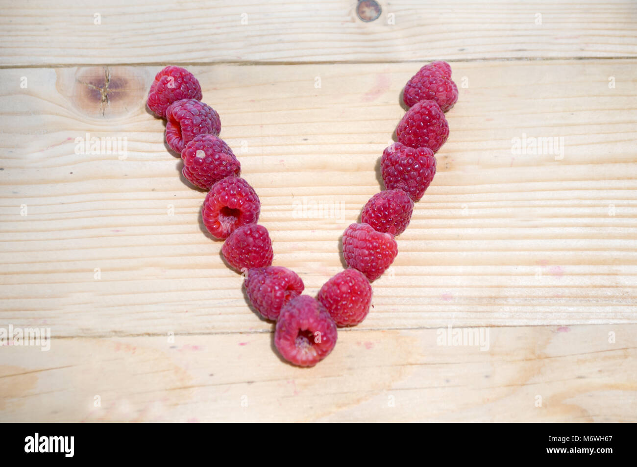 Alphabetical letters made of raspberries on a white background Stock ...