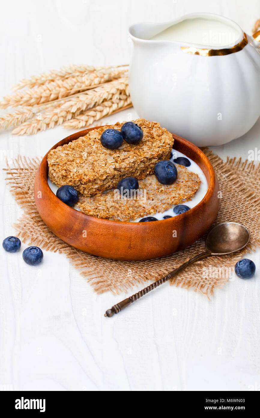 Wholegrain wheat bisks with milk and blueberry Stock Photo - Alamy
